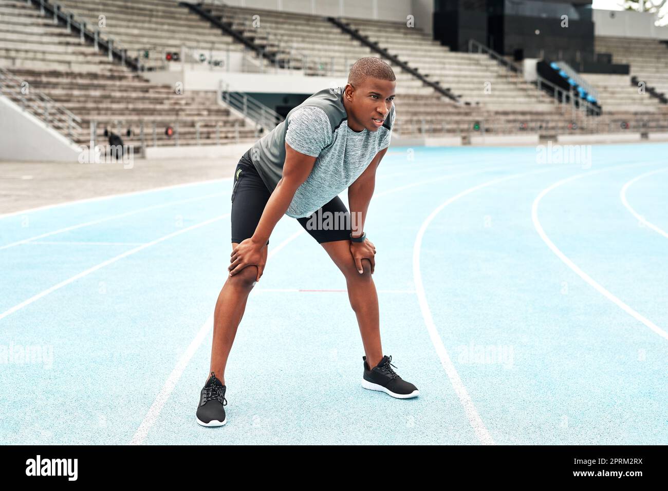 I need to catch my breath. Full length shot of a handsome young athlete ...