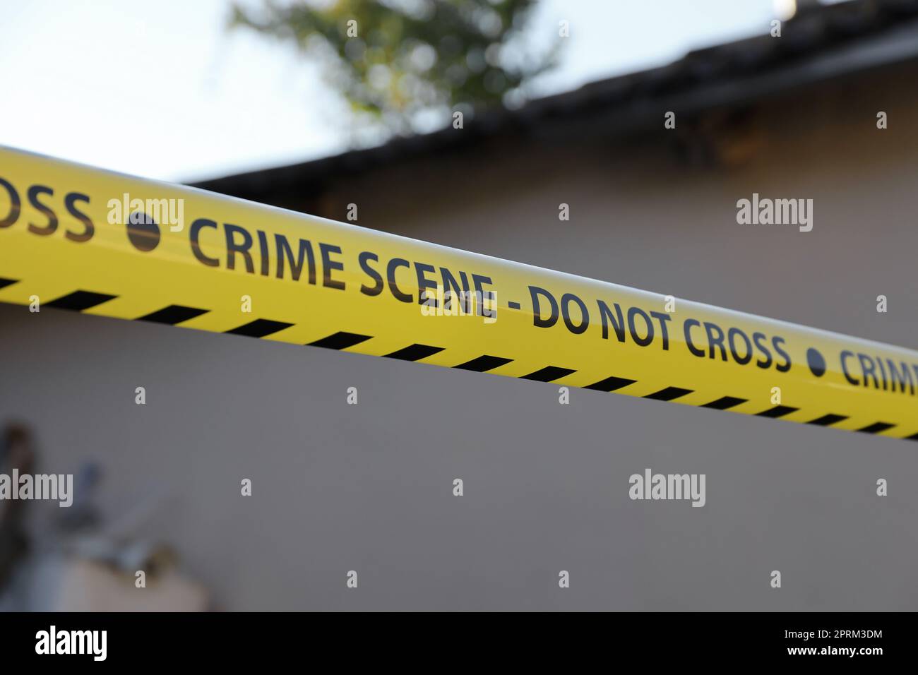 Crime scene tape for covering the area cordon. Yellow tape with blurred ...