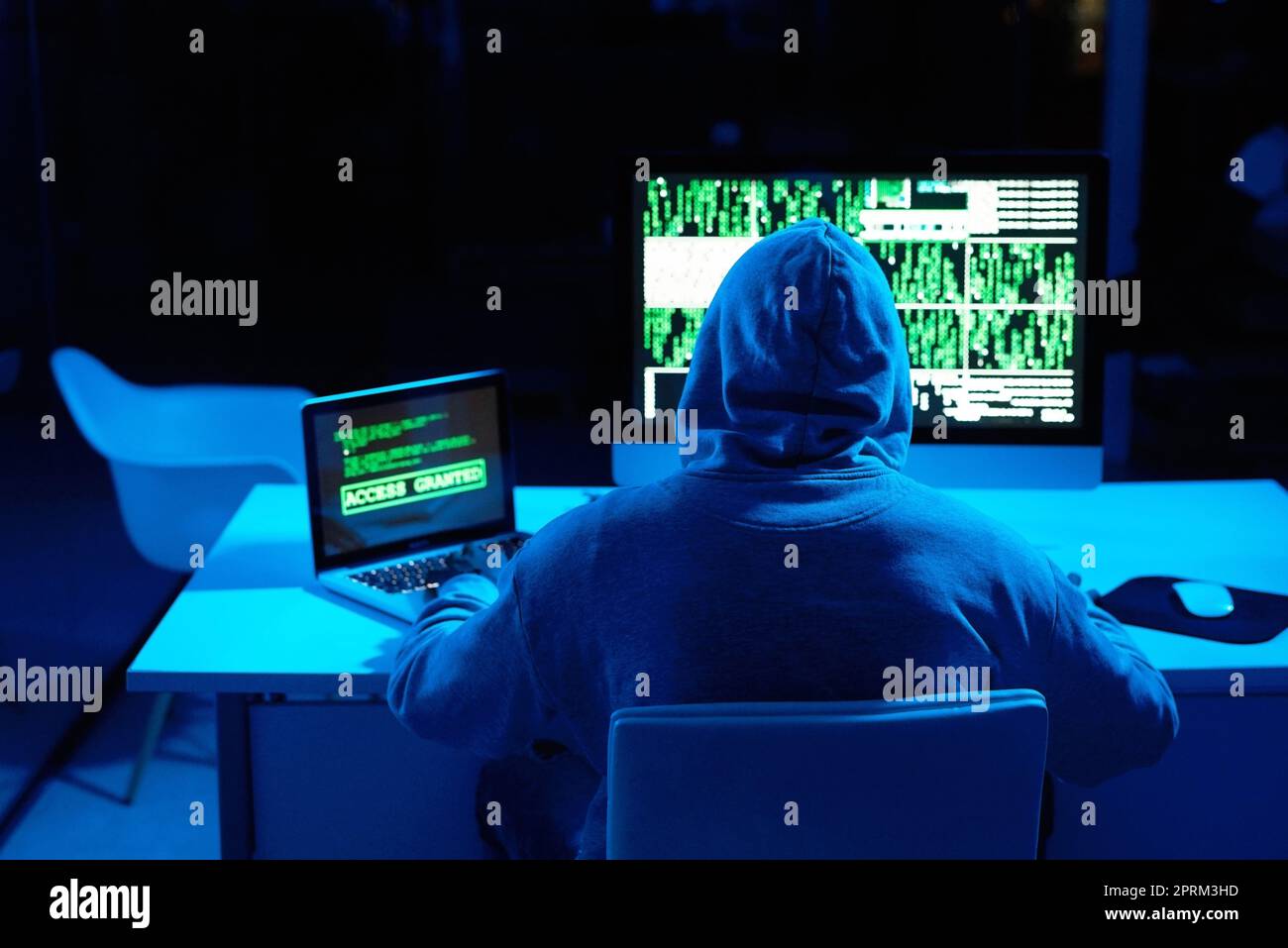 Back up everything you can before its too late. Rearview shot of a male hacker cracking a ...