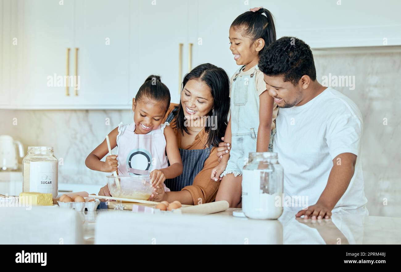 Happy, mother and father baking with children for family bonding, learning and teaching in the ...
