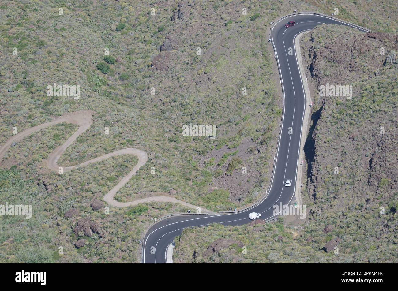 Cars on a winding road. The Nublo Rural Park. La Aldea de San Nicolas ...