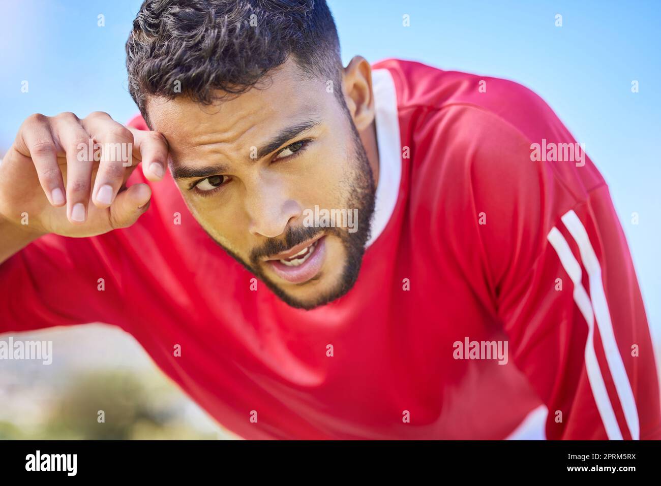 Soccer, sports and tired young athlete at a game, training or workout ...