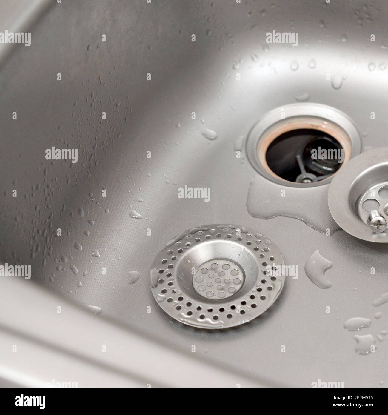 Silvery kitchen sink with a disassembled protective filter. Kitchen ...
