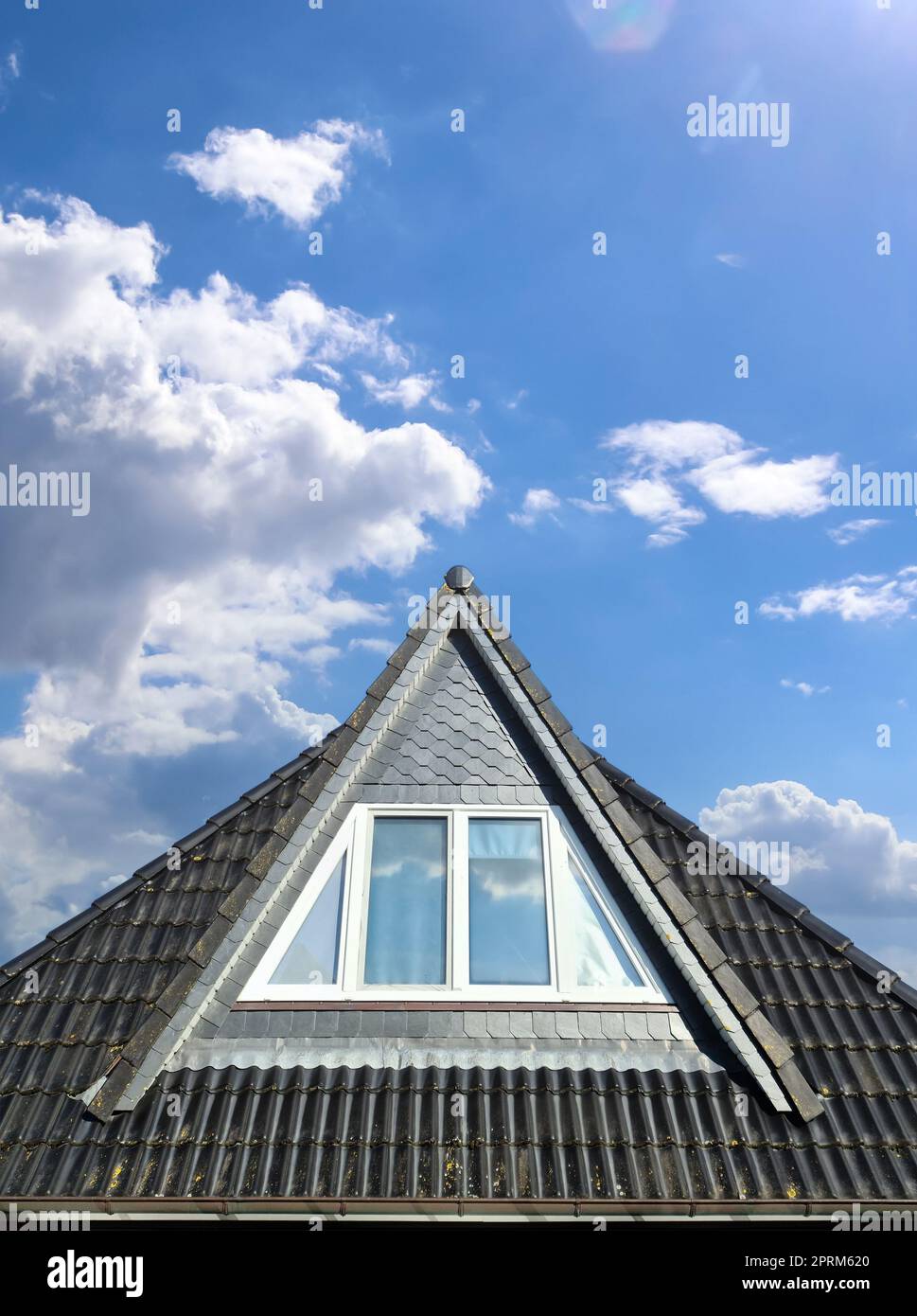 Roof window in velux style with black roof tiles Stock Photo - Alamy