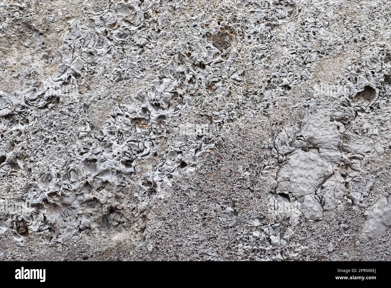 Aged concrete wall of historical building with cracks and a lot of ...