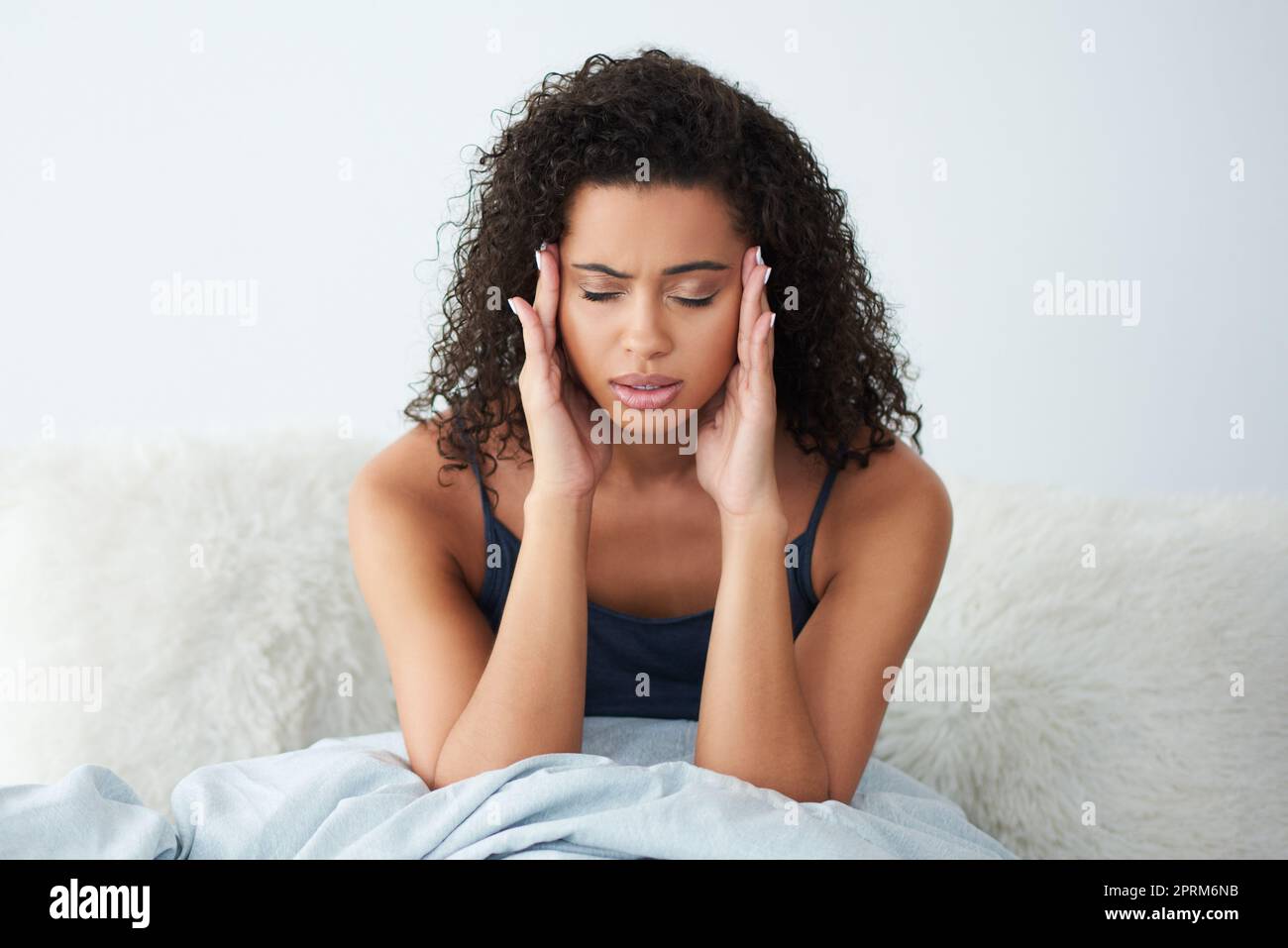 Rubbing her head hi-res stock photography and images - Alamy