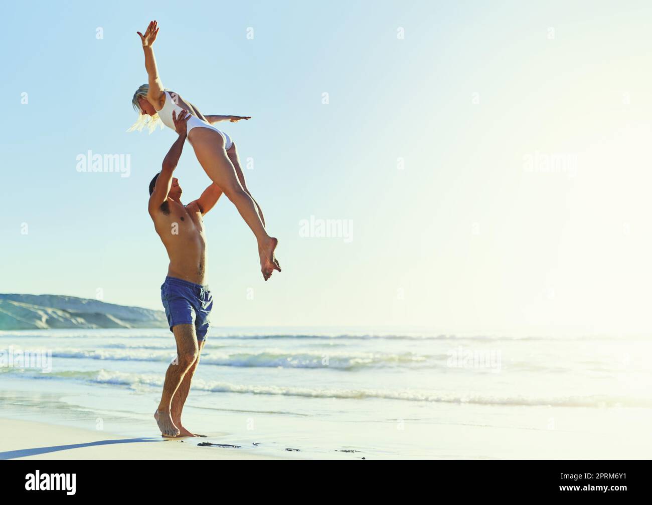 Summer Is Simply A Time For Endless Fun A Young Man Lifting His