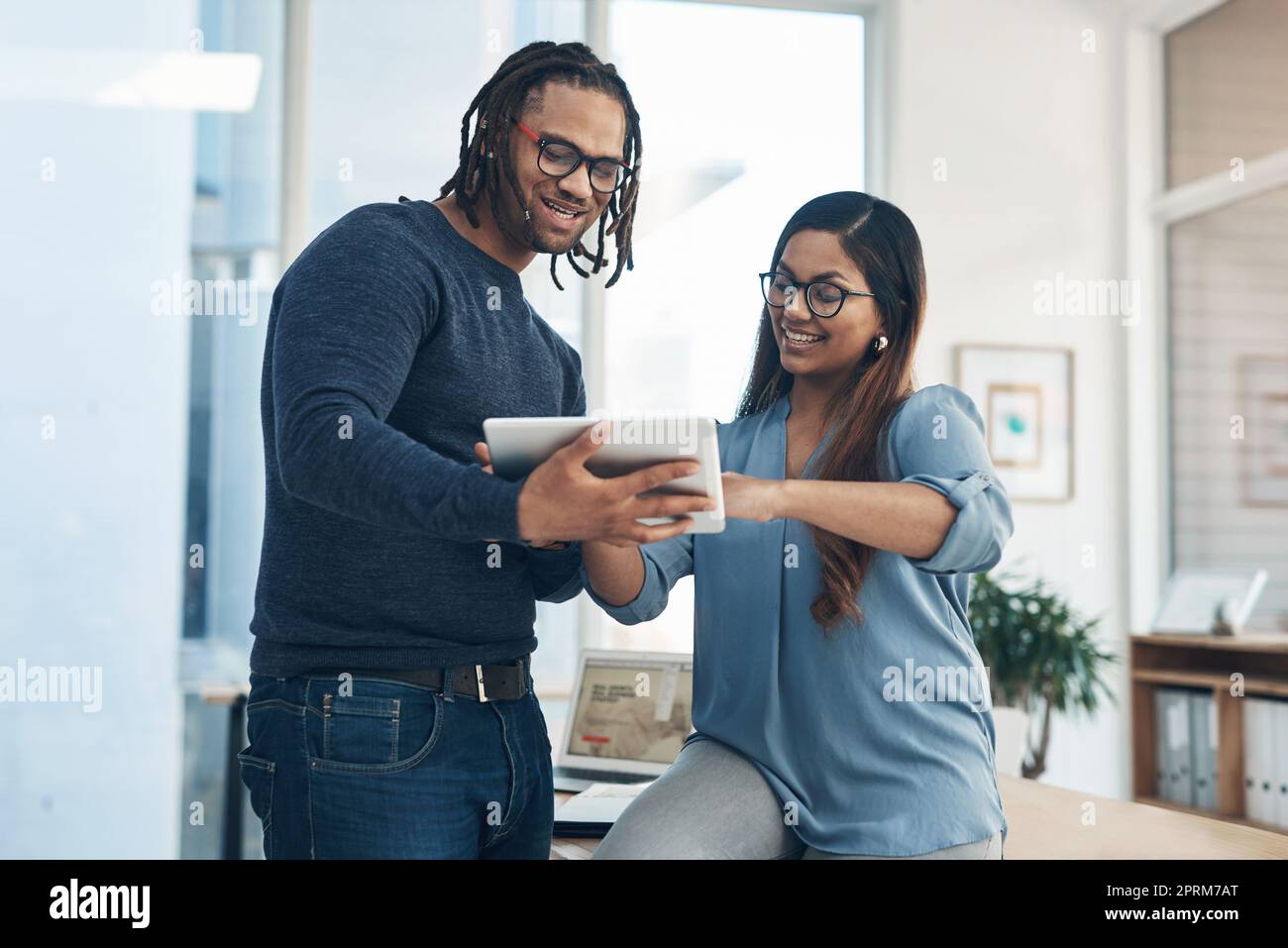 Exploring all their options with ease. two businesspeople using a ...