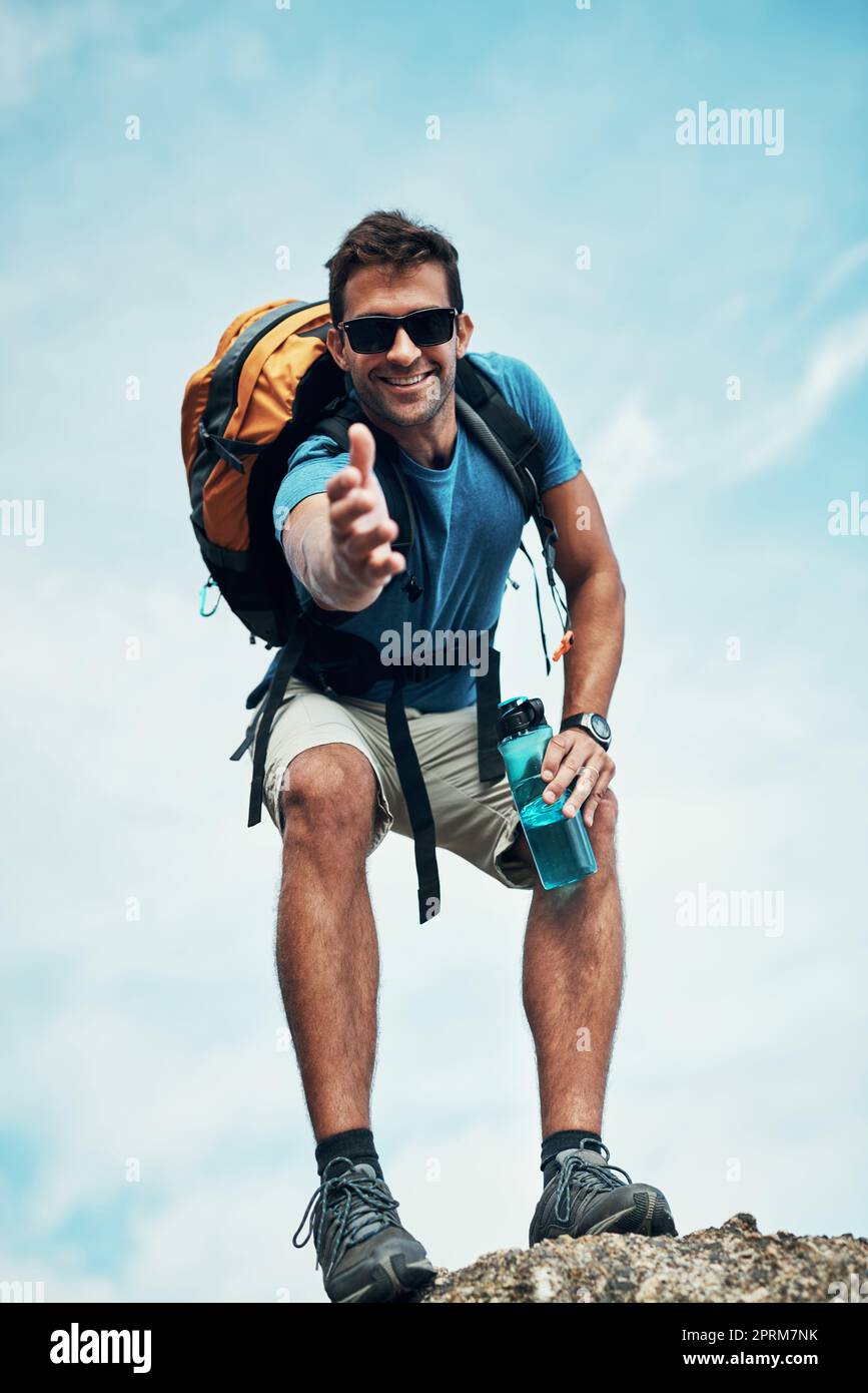 Take my hand. Portrait of a cheerful young man stretching out his hand ...