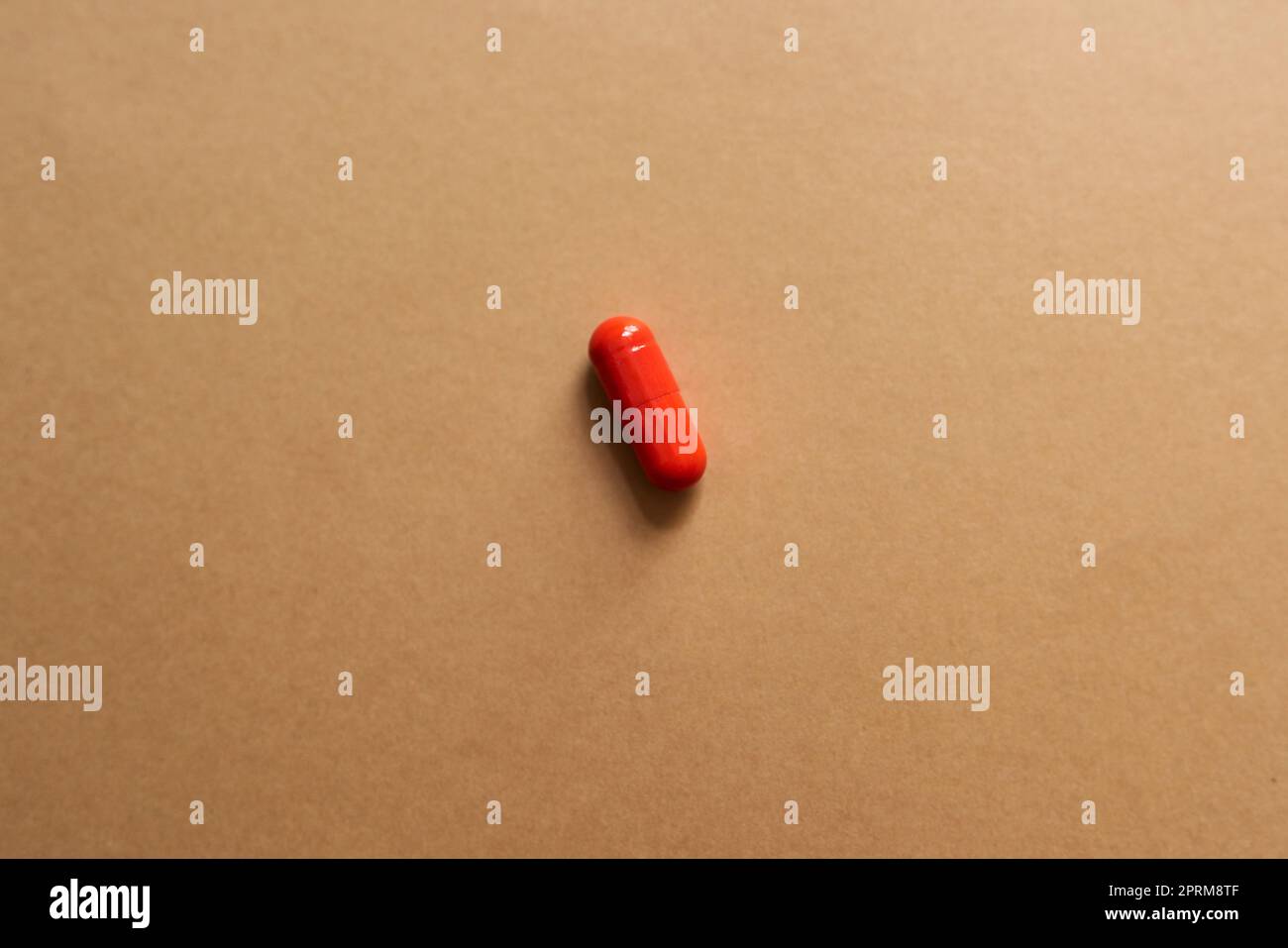 One capsule that cares for your wellbeing. Studio shot of a single red ...