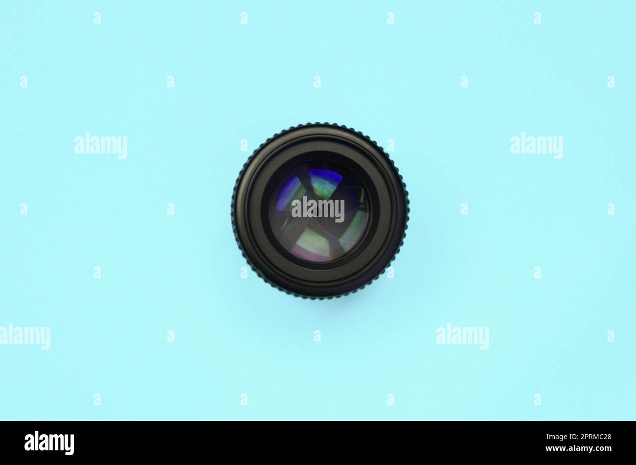 Camera lens with a closed aperture lie on texture background of fashion ...