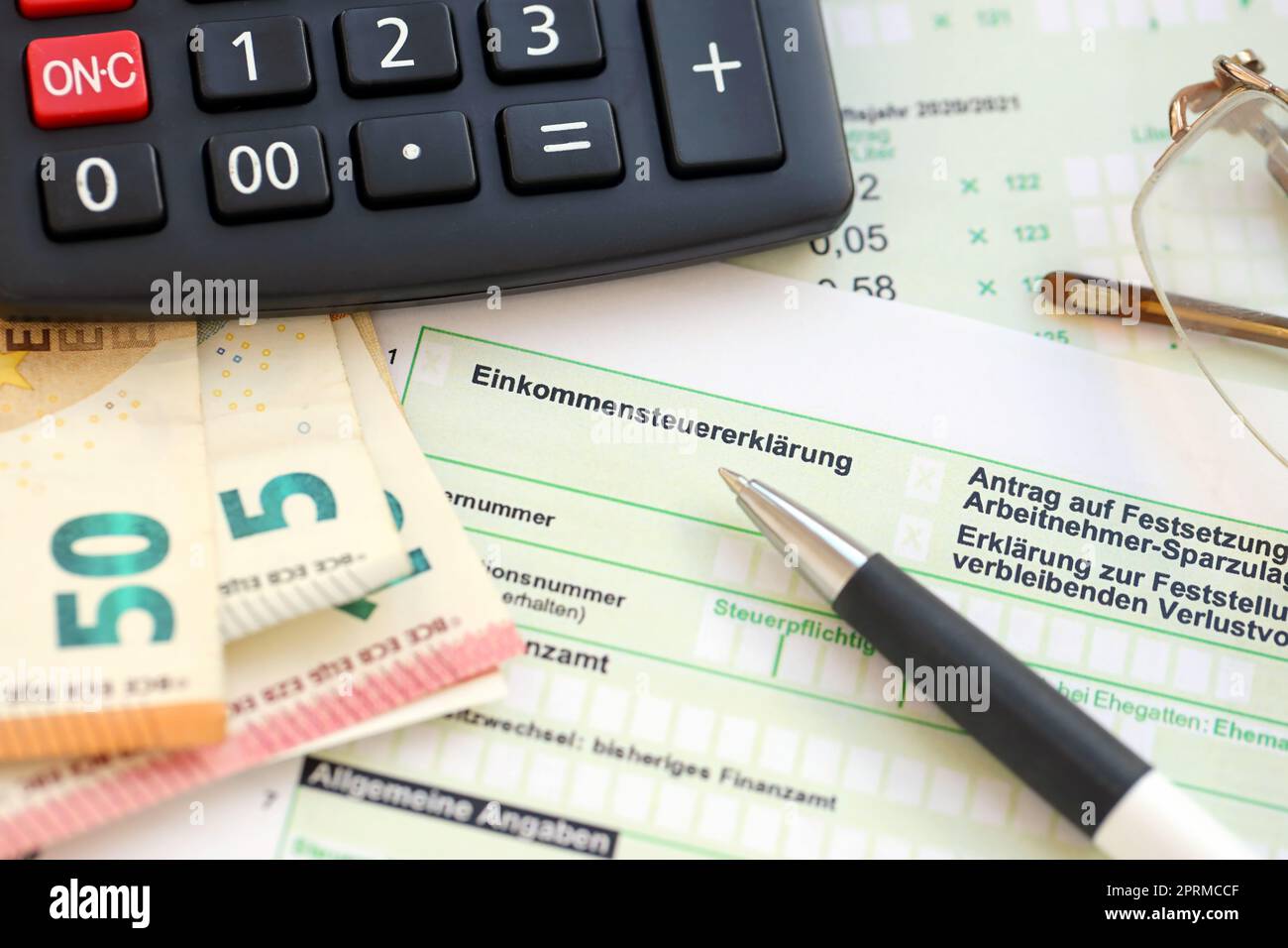 German income tax return form with pen and european euro money bills ...