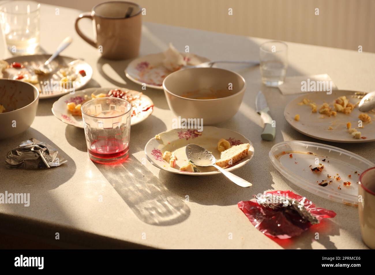 Empty dirty plates with spoons and forks on the table after meal ...