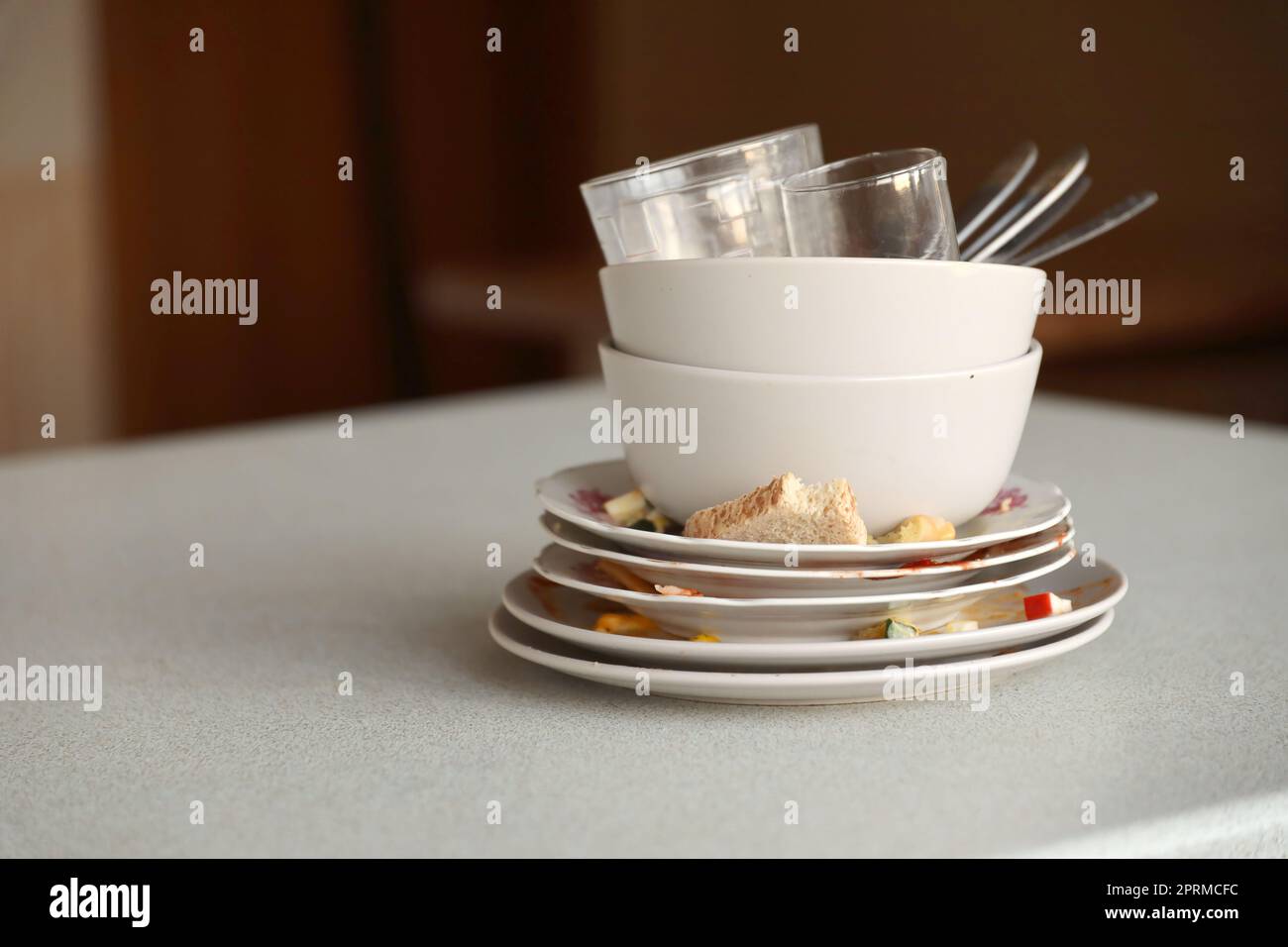 Stack of dirty dishes with food leftovers on the table after meal ...