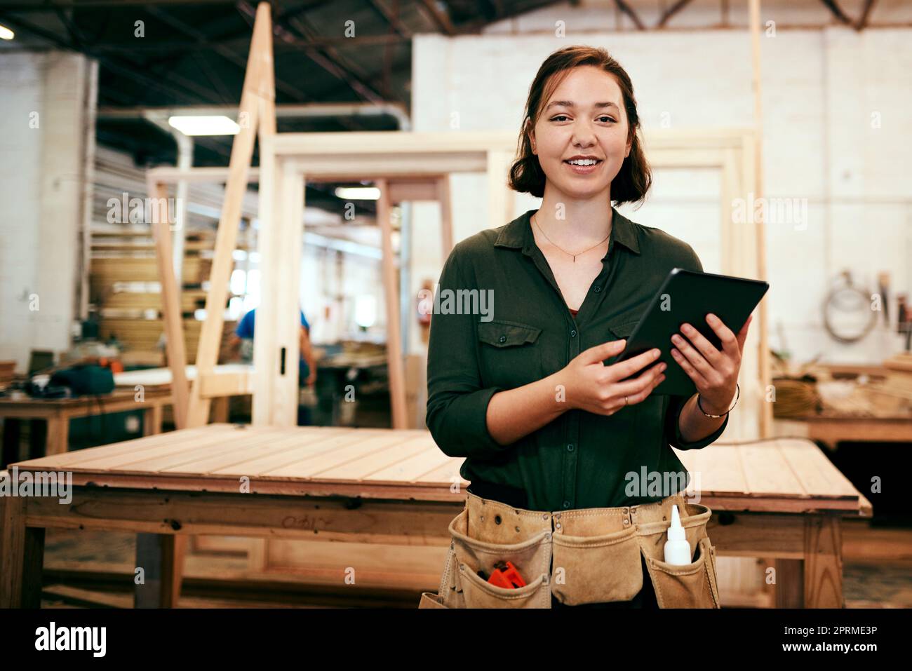 We do vintage and modern styles. a female carpenter using a digital ...