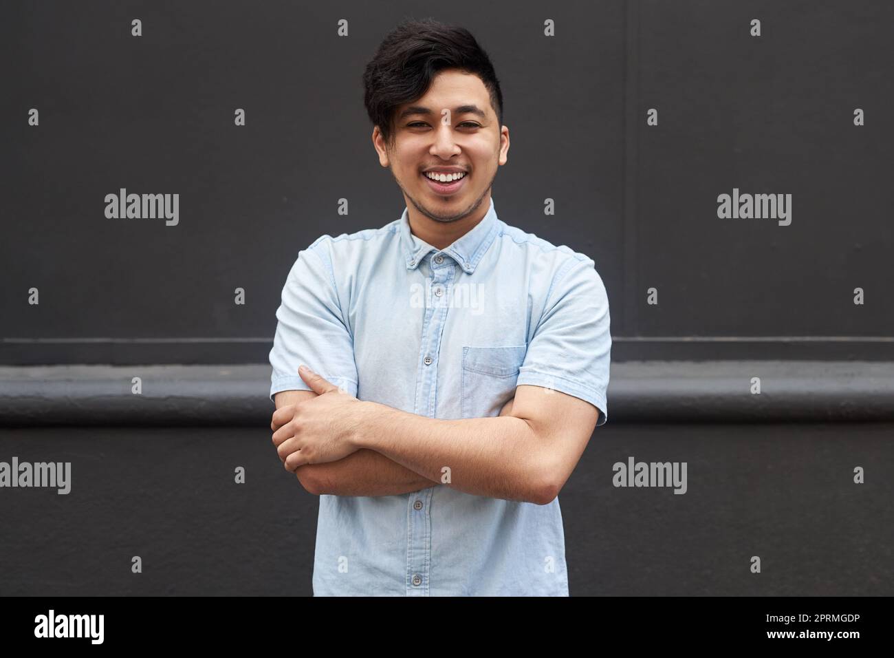 Young man arms folded hi-res stock photography and images - Alamy