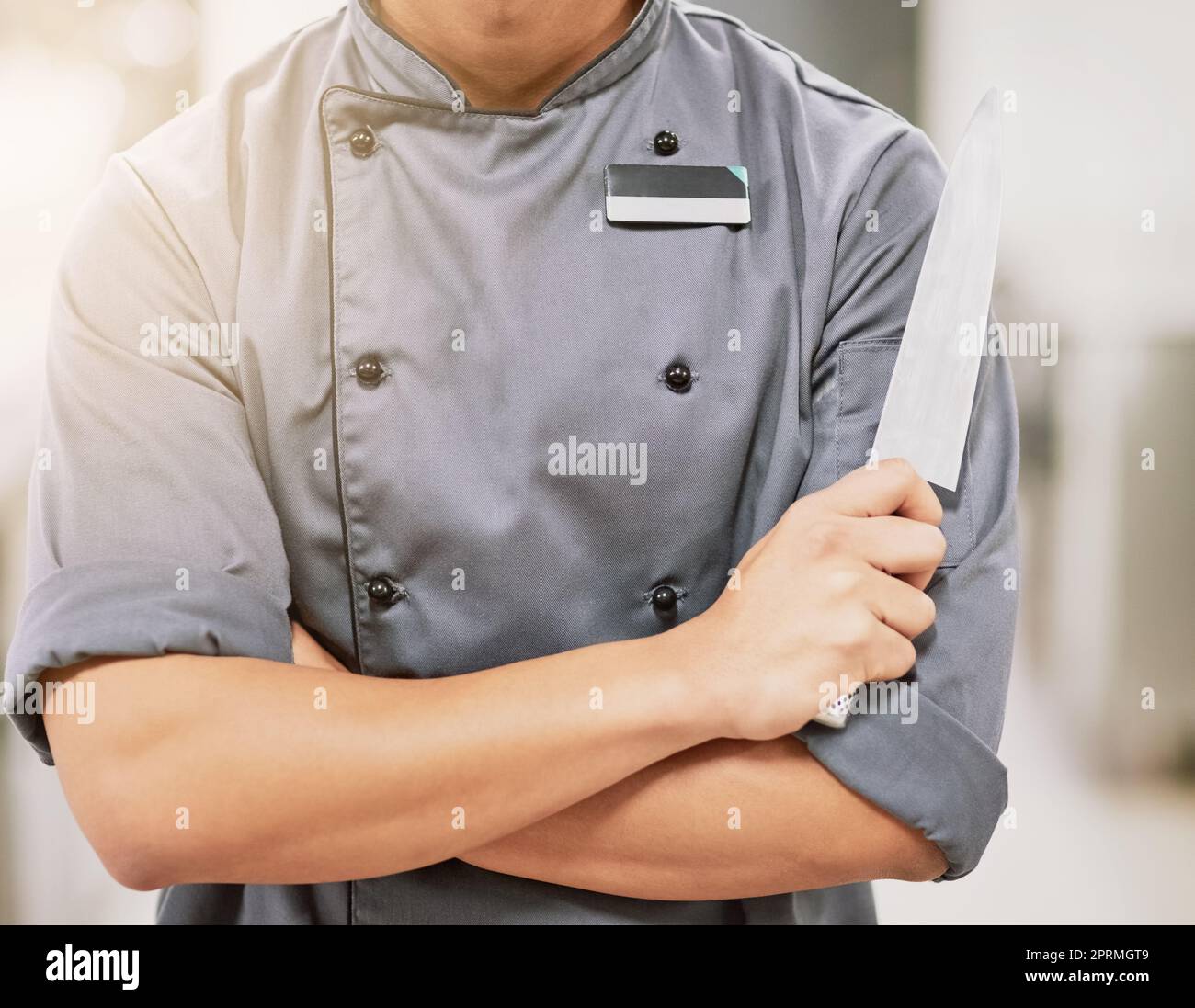 No kitchen is complete without a knife. an unrecognizable chef holding ...