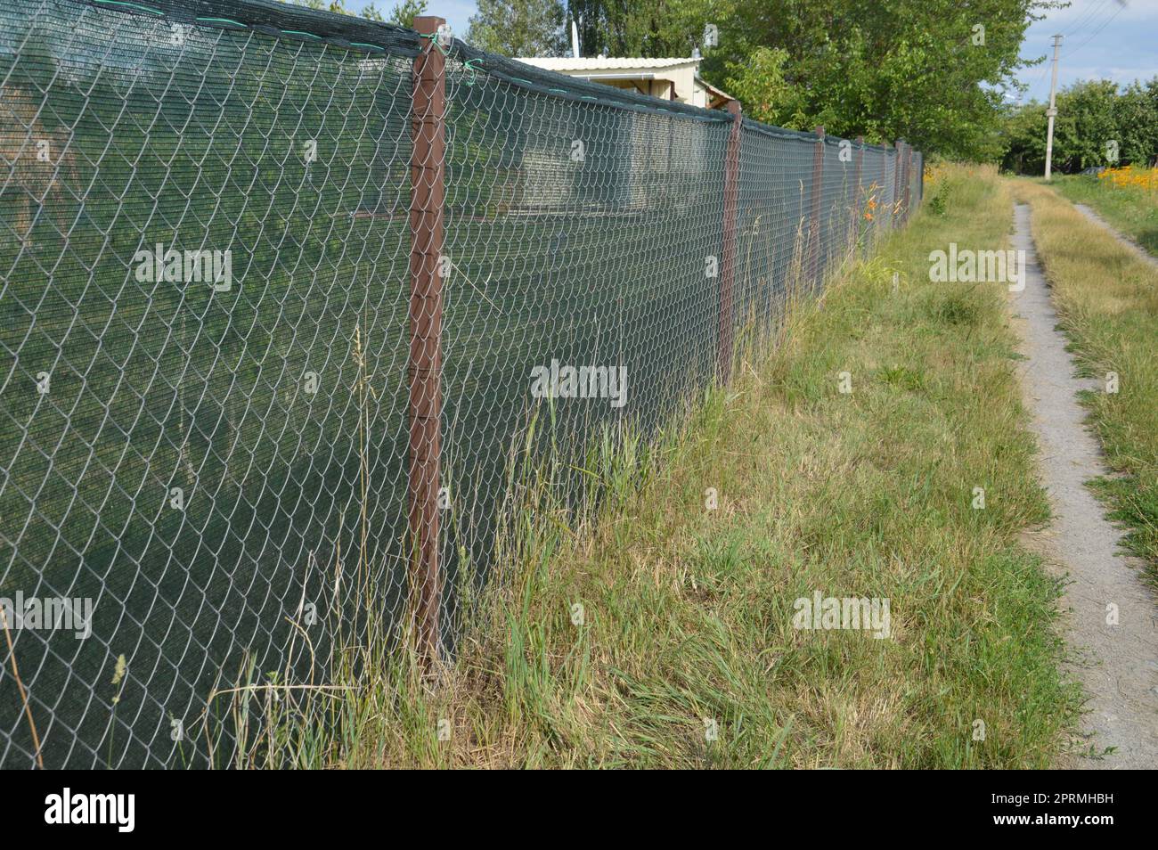 Installation of a shading net on a the chain-link fence Stock Photo - Alamy