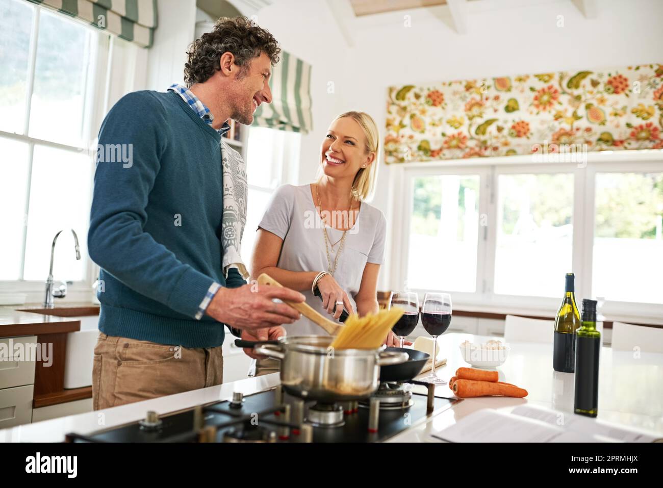 Blonde woman cooking husband hi-res stock photography and images - Alamy
