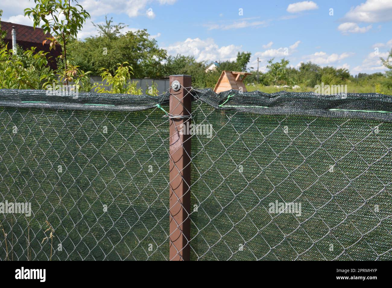 Installation of a shading net on a the chain-link fence Stock Photo - Alamy