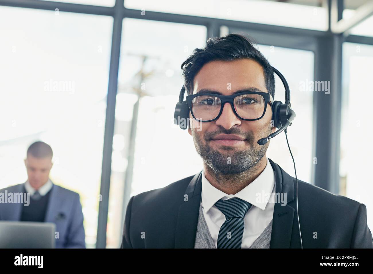 Lets talk about success. Portrait of a friendly support agent working ...