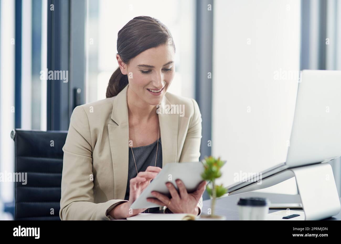 Simplifying work tasks with smart technology. a professional businesswoman using a digital ...