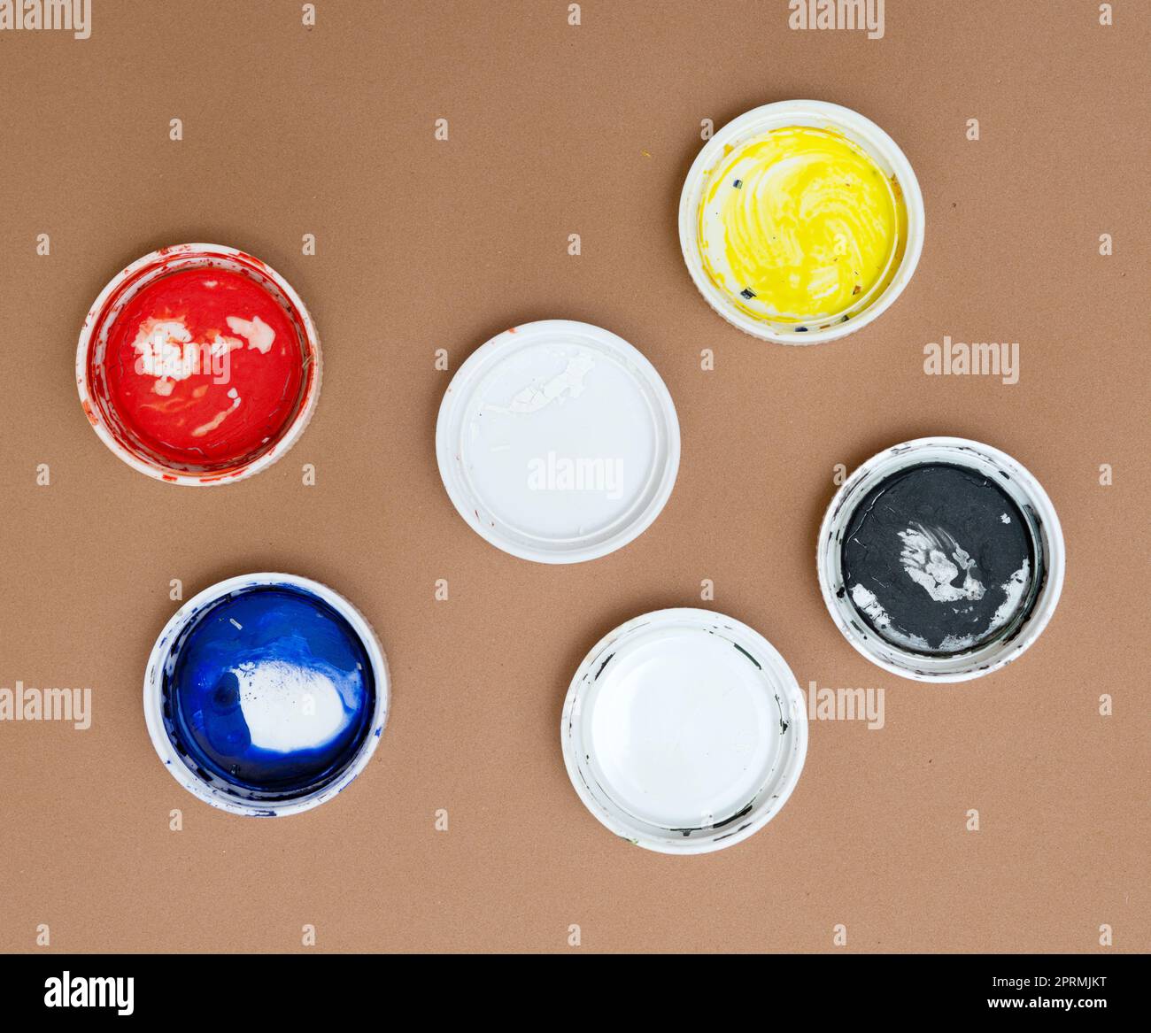 Colored lids on brown. Top view Stock Photo - Alamy