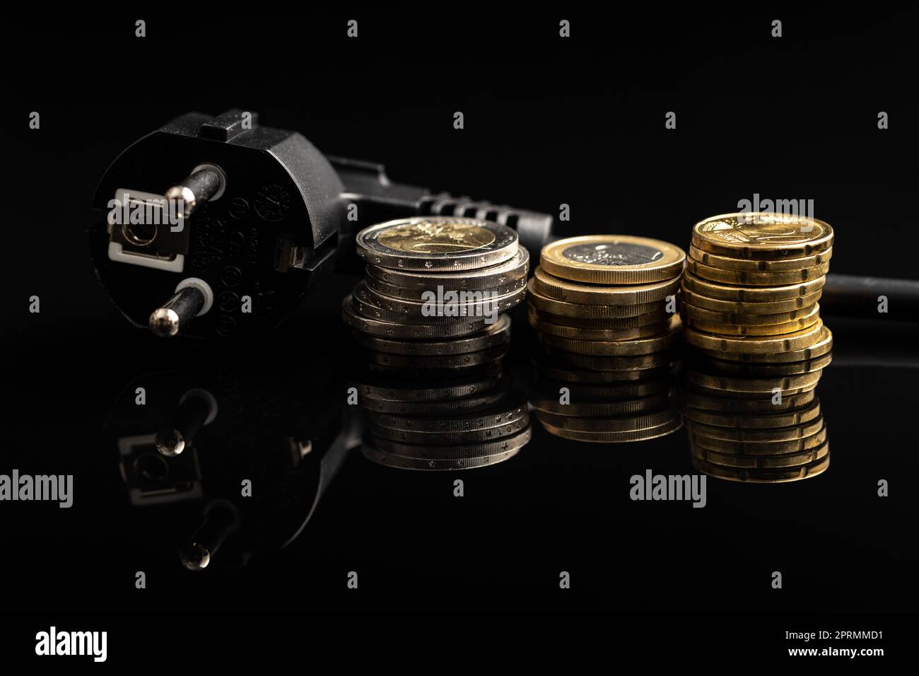 Black electric plug and euro coins on black background. Concept of ...
