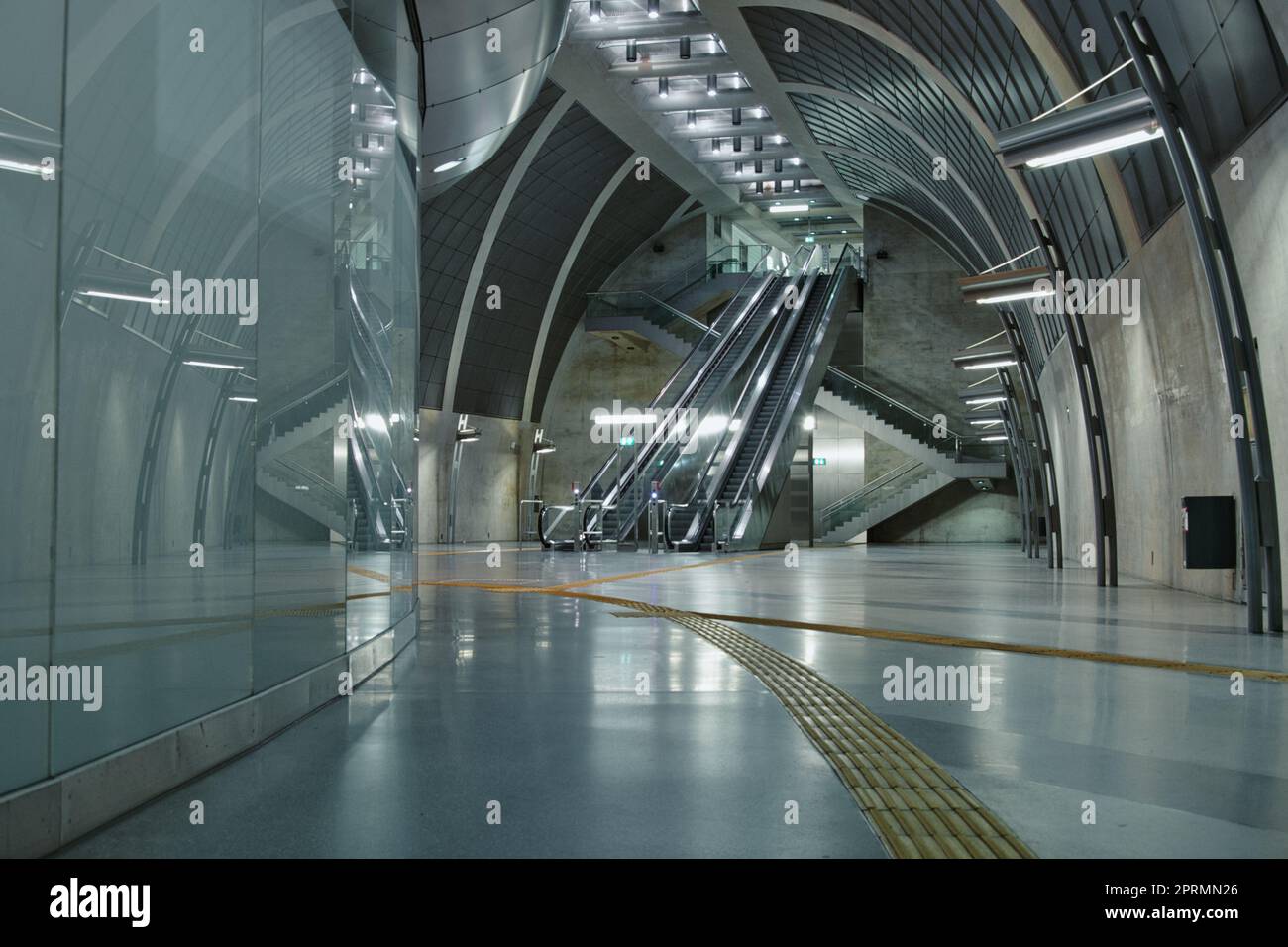 Futuristic subway station with guiding lines and an escalator near ...