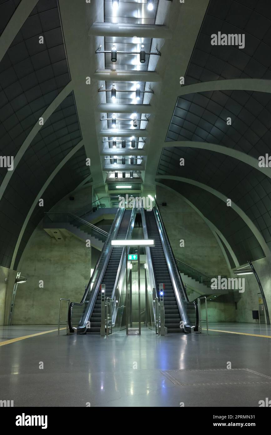 Futuristic subway station with guiding lines and an escalator near ...