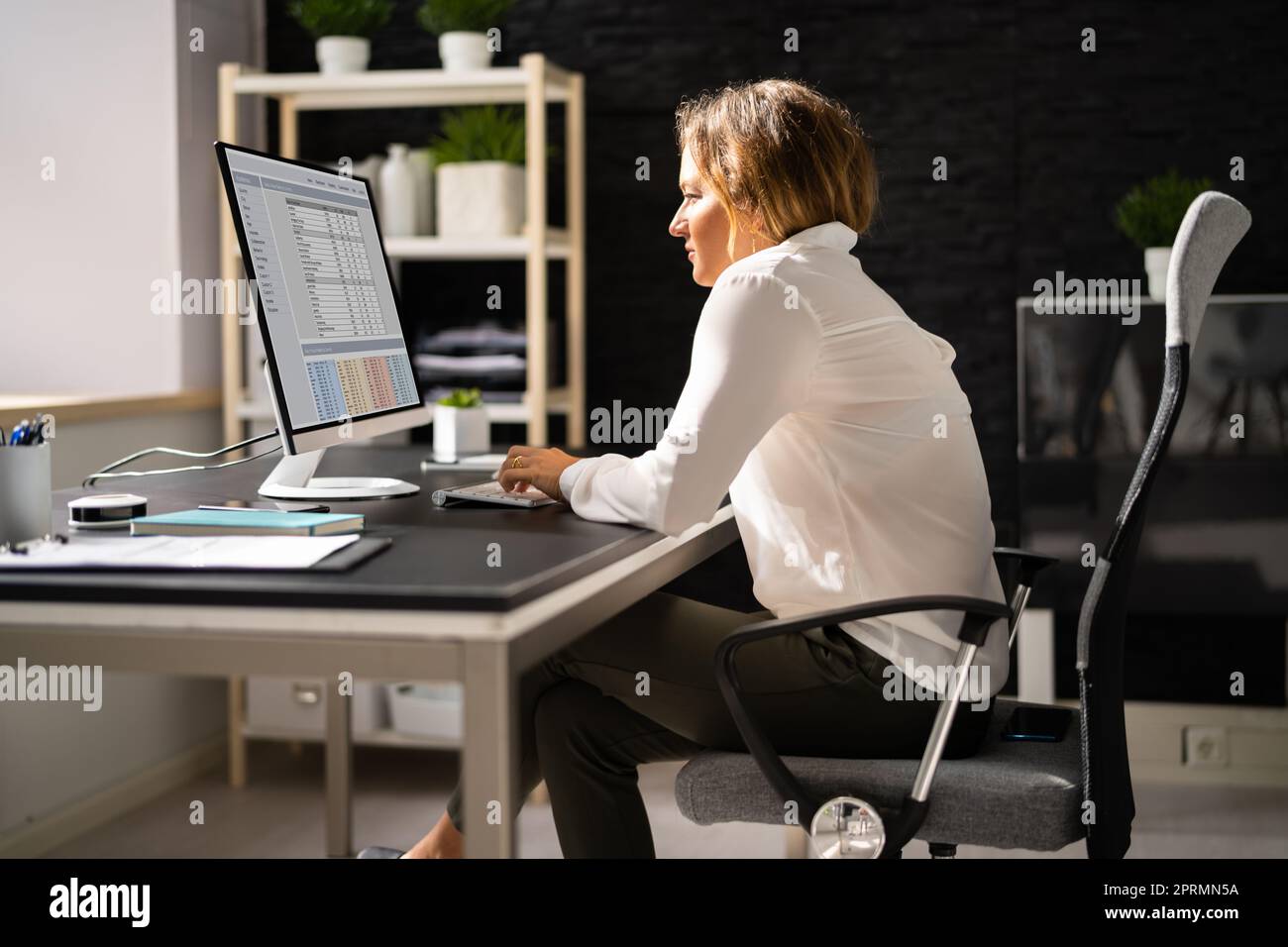 Woman Sitting In Bad Posture Working On Computer Stock Photo - Alamy