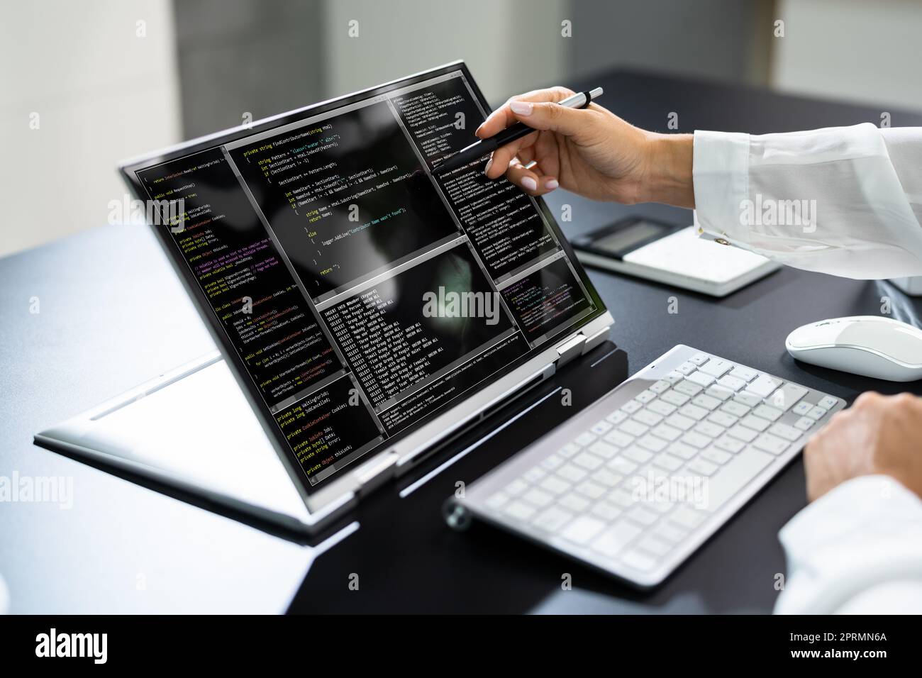 Programmer Or Coder At Office Desk Using Laptop Stock Photo - Alamy
