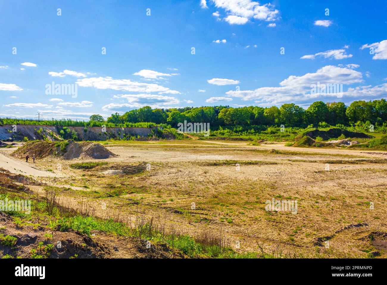Excavated sand mountains and rubble piles quarry lake dredging pond ...