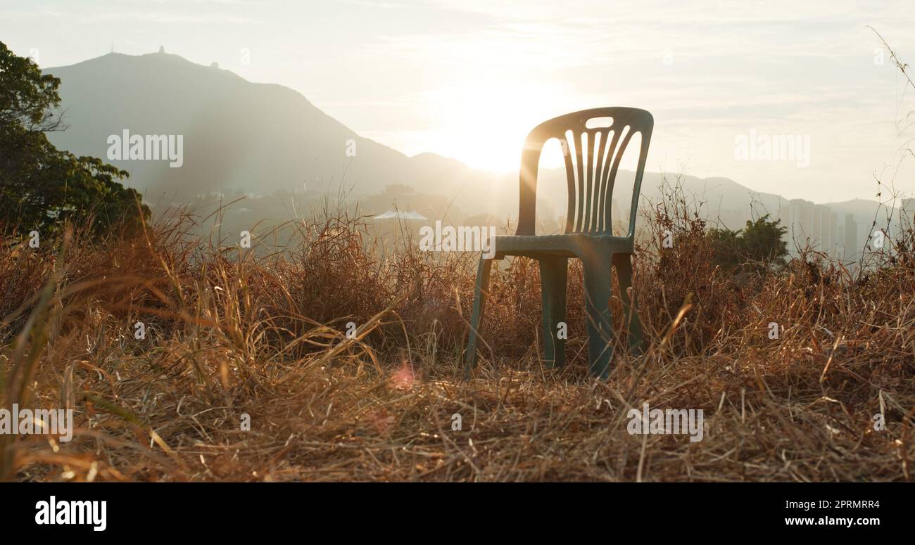 Sunset sunlight flare over the chair in tall grass Stock Photo - Alamy