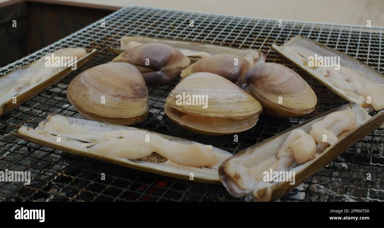 Fresh Short necked clam and Razor Clam on barbecue net Stock Photo - Alamy