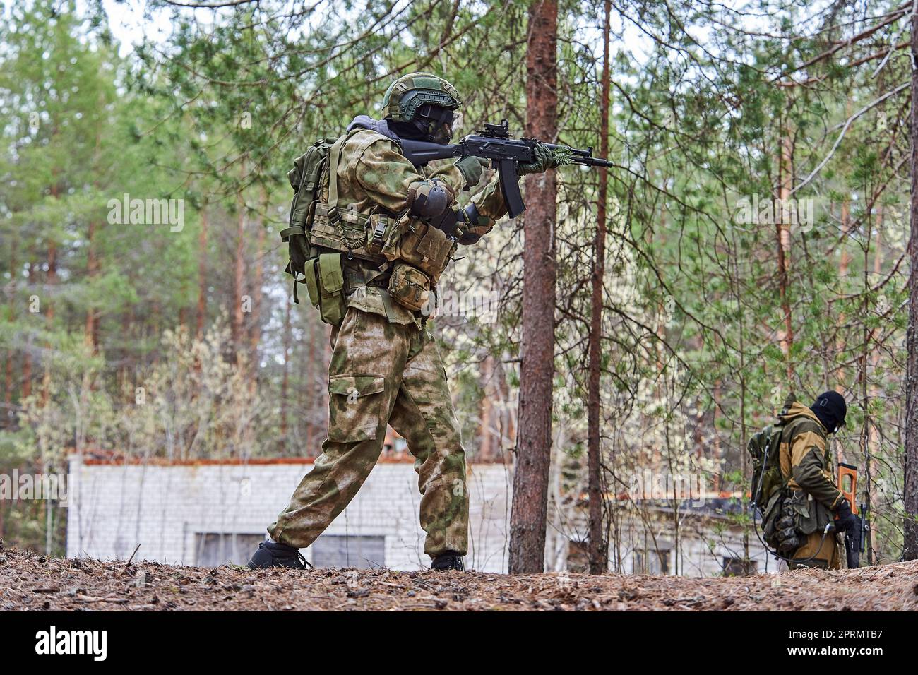 a man in the forest shoots from a machine gun Stock Photo - Alamy