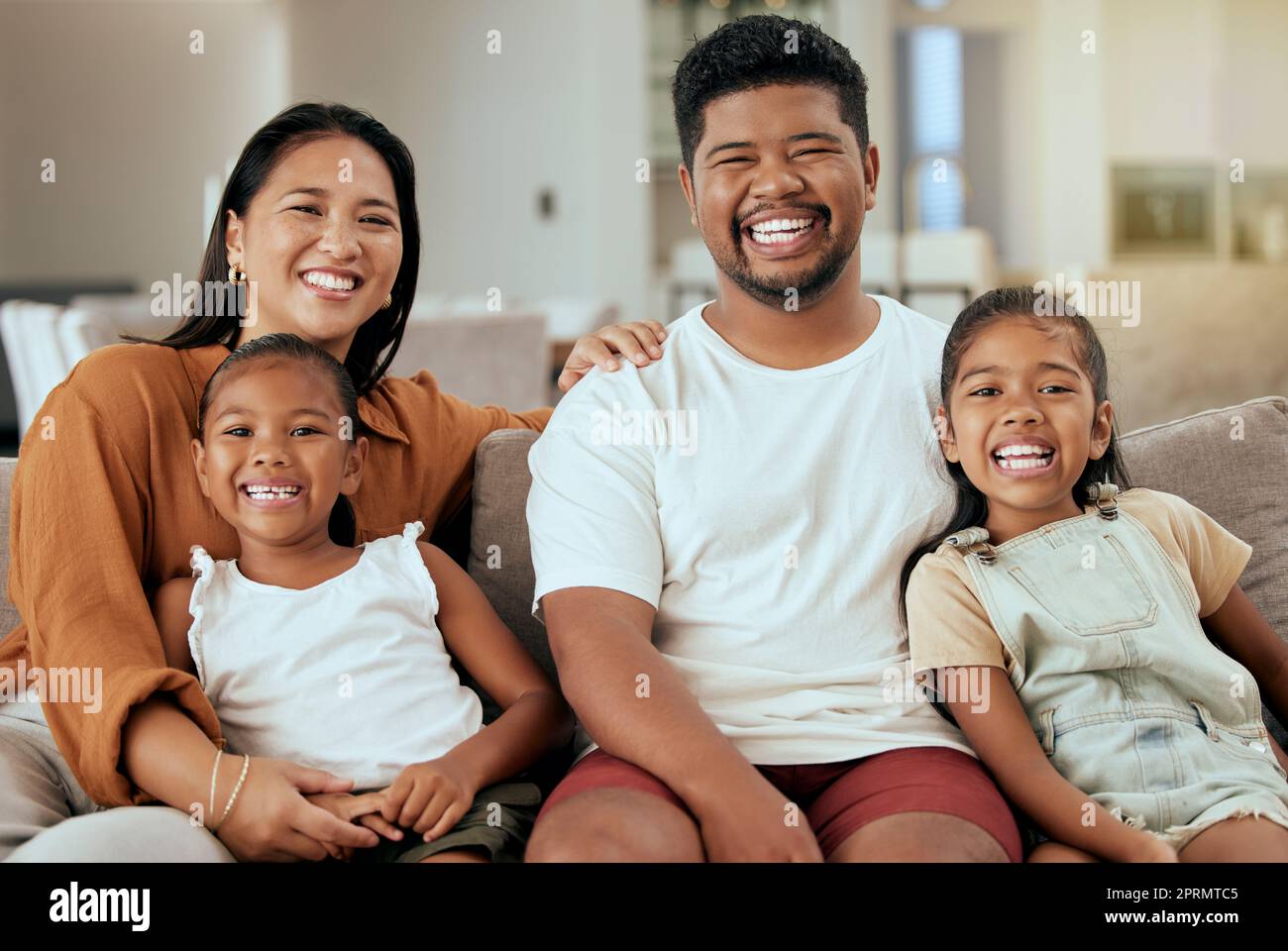 Family, parents with children and together in family home, smile in ...