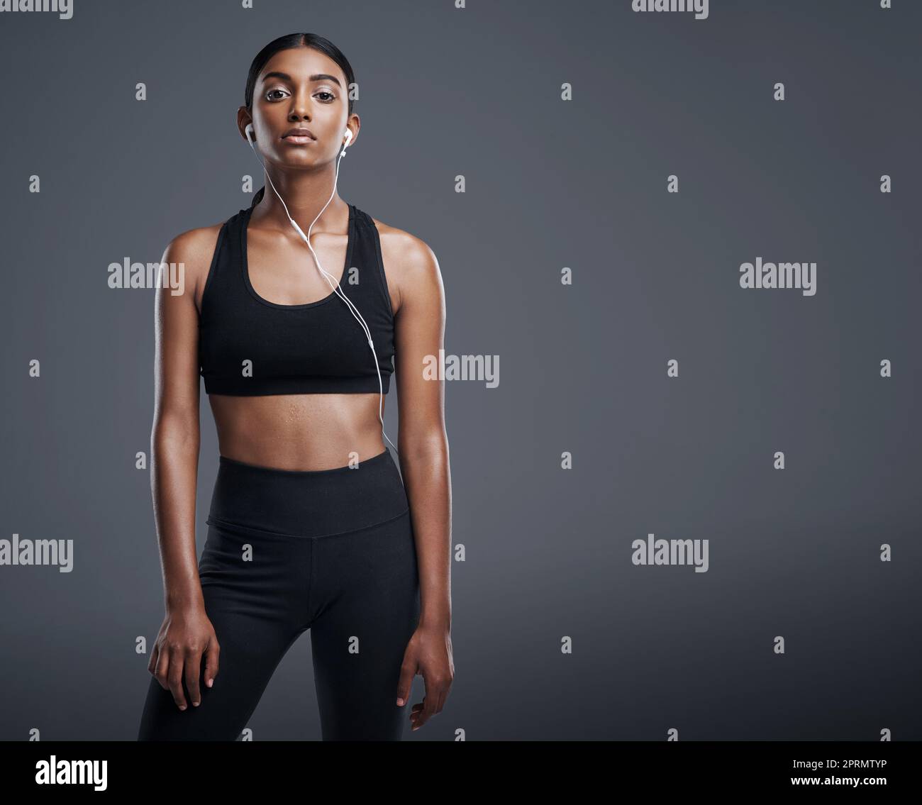 Music pumps some stamina too. Studio portrait of a sporty young woman ...
