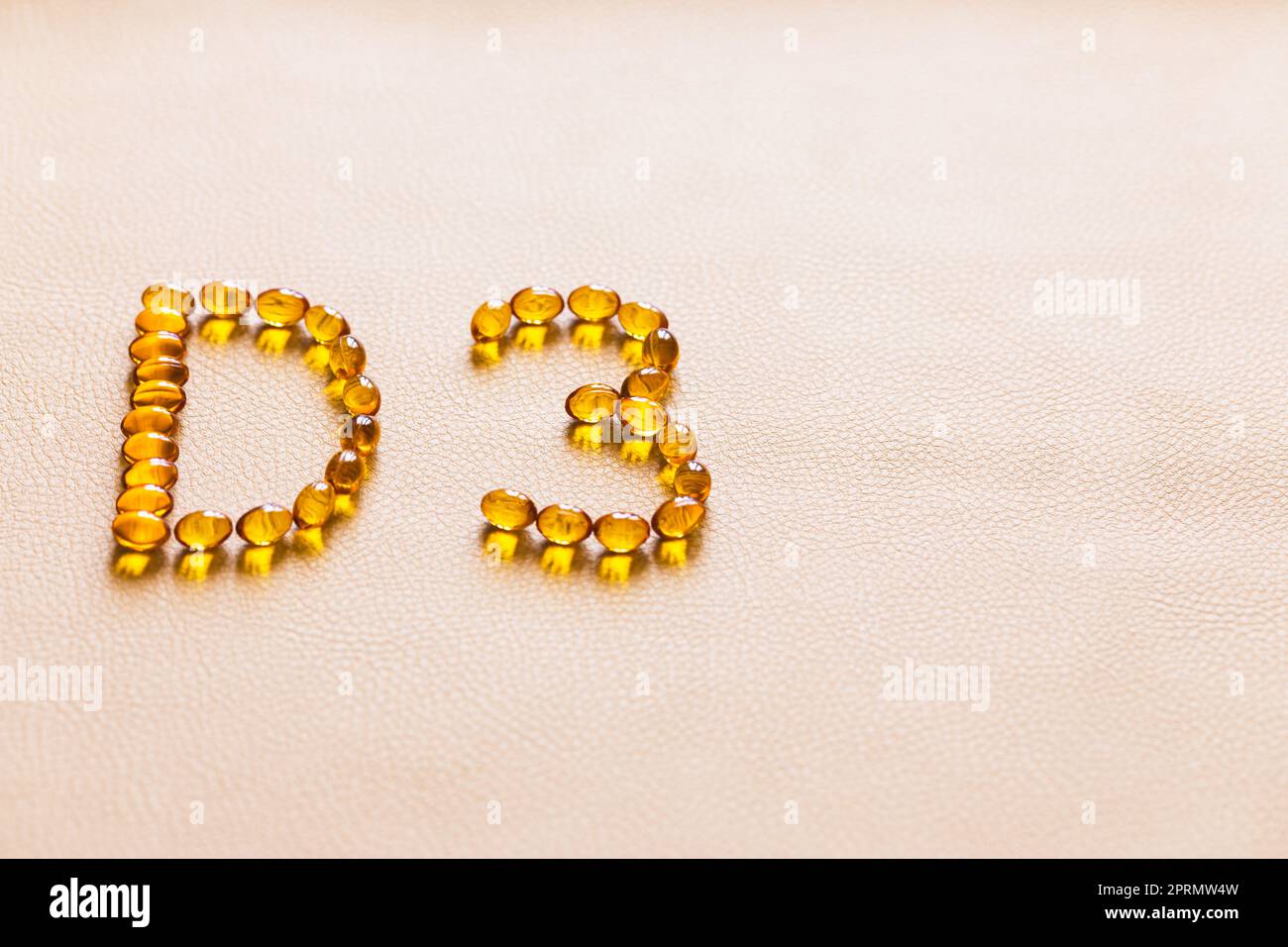 Bright oil yellow pills forming shape D3. Vitamin D3 capsules. Medicine ...