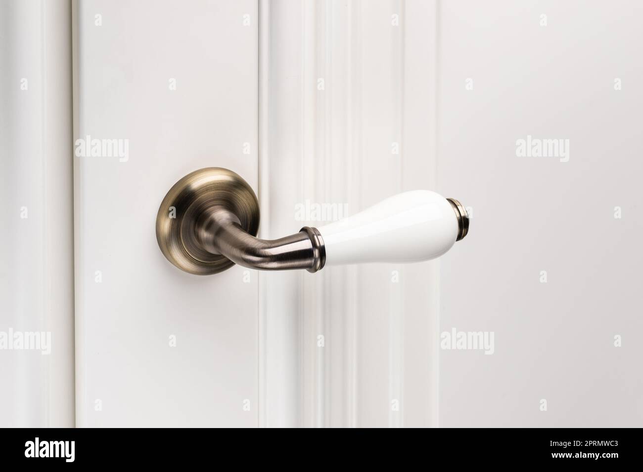 Close up of stylish and elegant door knob or handle on white door Stock Photo - Alamy
