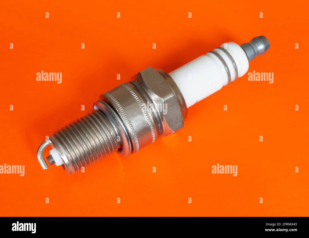 The Car spark plug on orange background. Electric device for machine ...