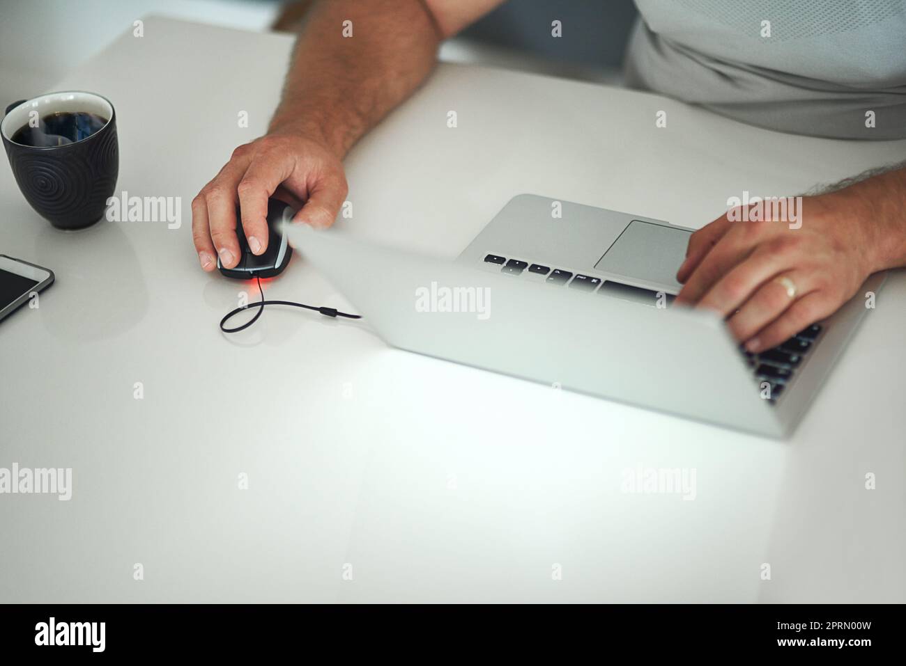 Getting some work done. an unrecognizable man working on his laptop ...