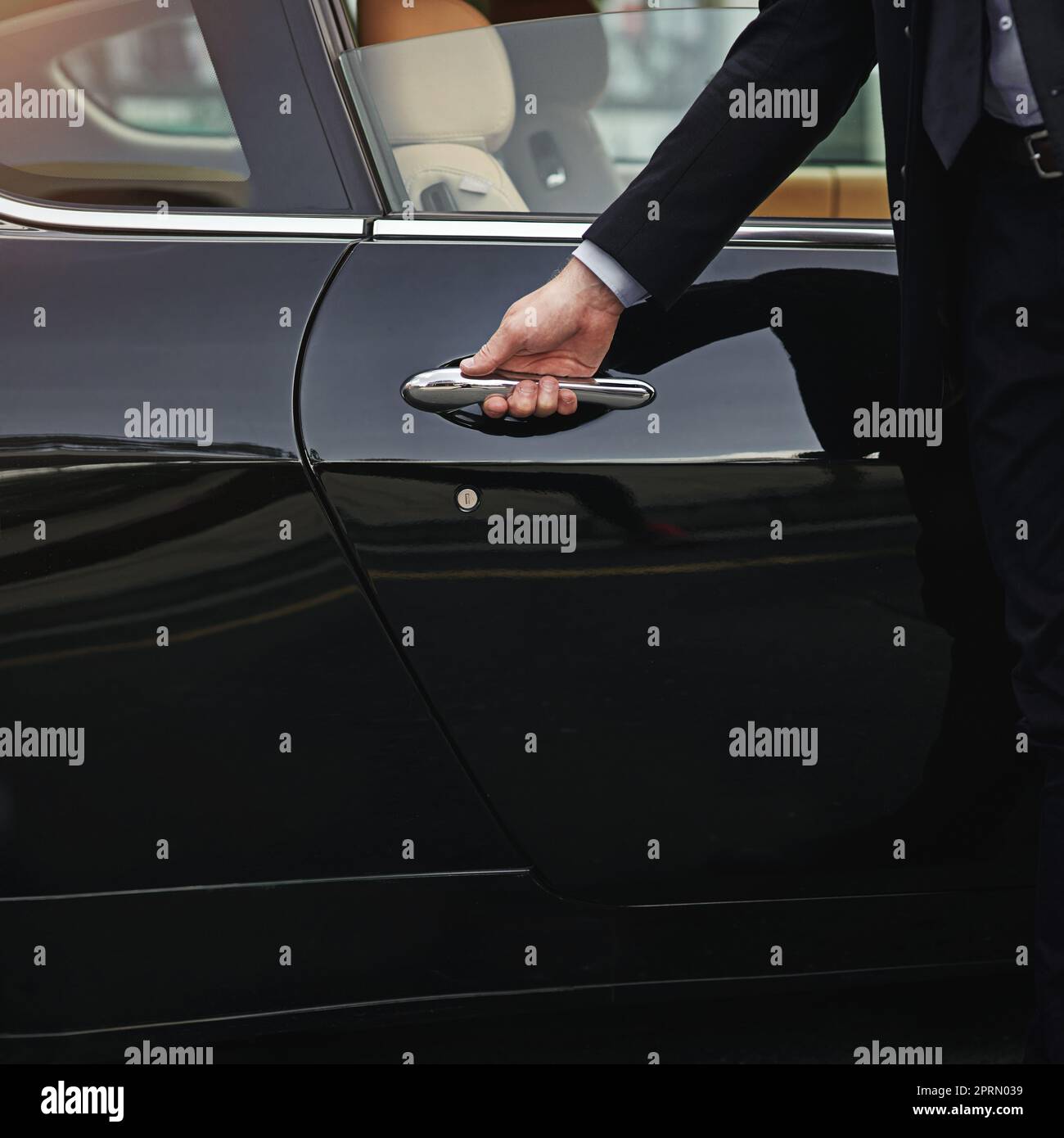 Top class transportation. a well dressed man opening a car door Stock ...