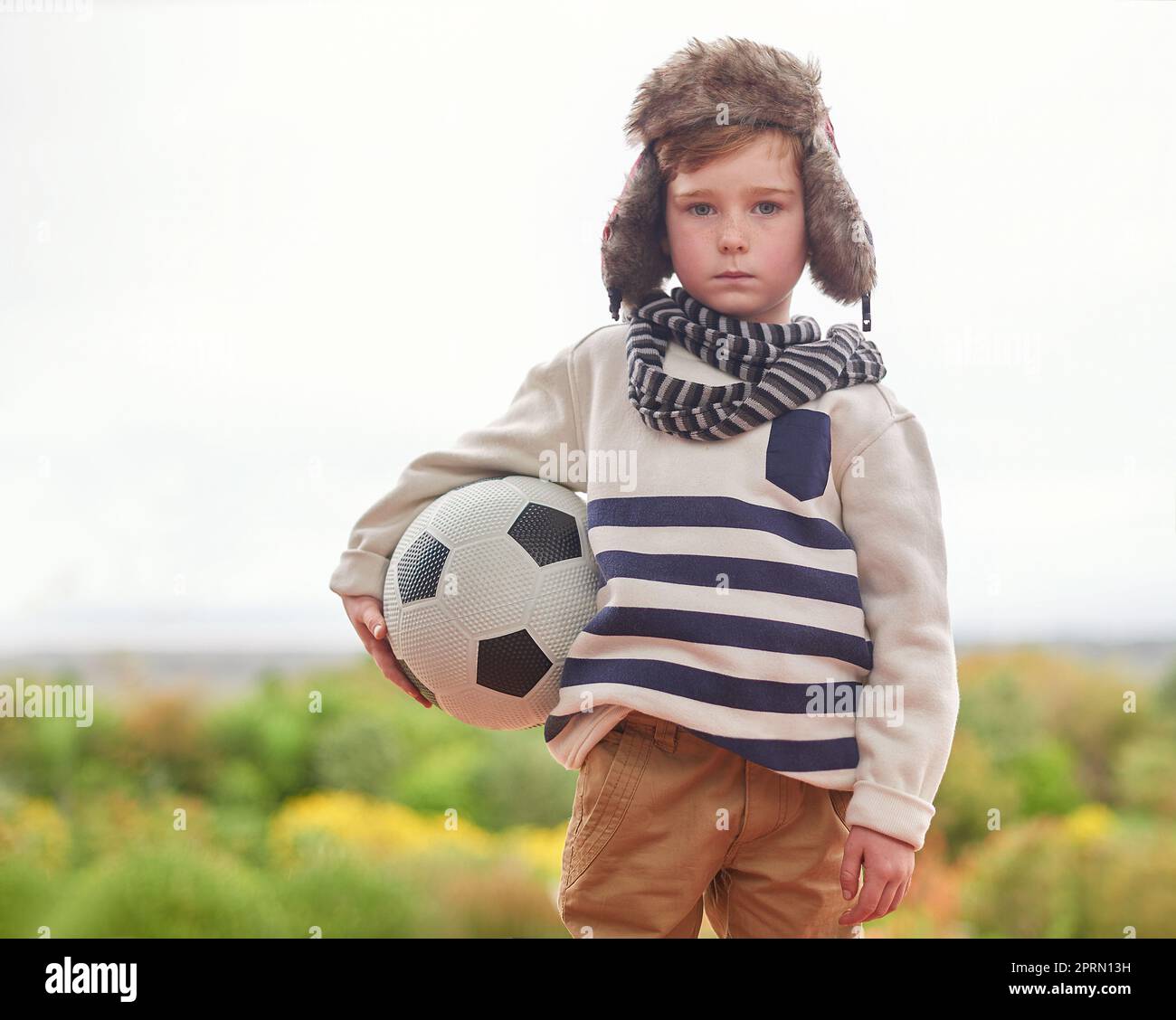 The weather wont let me play. a little boy standing outside in rainy ... The weather wont let me play. a little boy standing outside in rainy ...