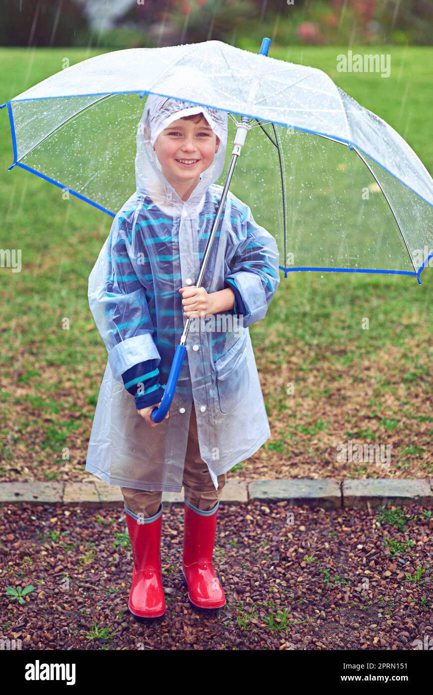 Just a boy in the rain. Full length portrait of a young boy standing ...