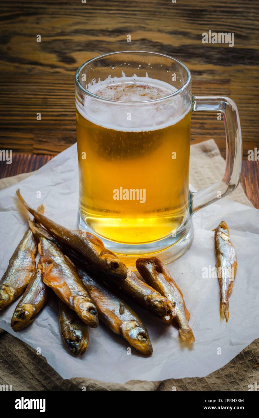 Light beer in a glass beer mug and smoked fish Stock Photo - Alamy