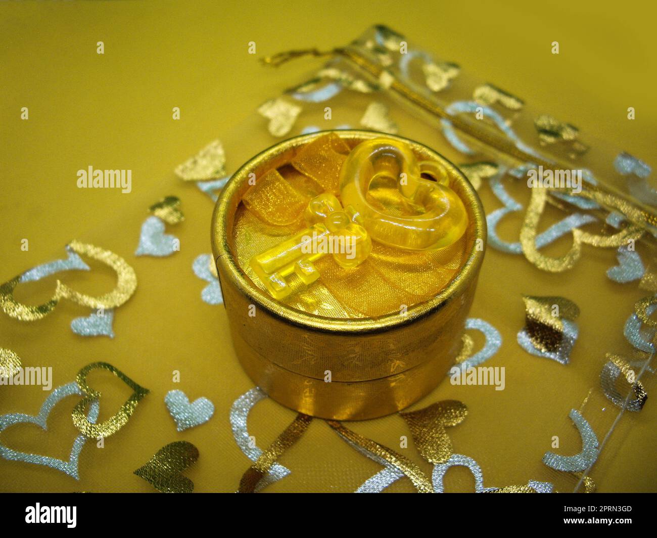Golden key in a cylindrical box on a yellow the background Stock Photo ...