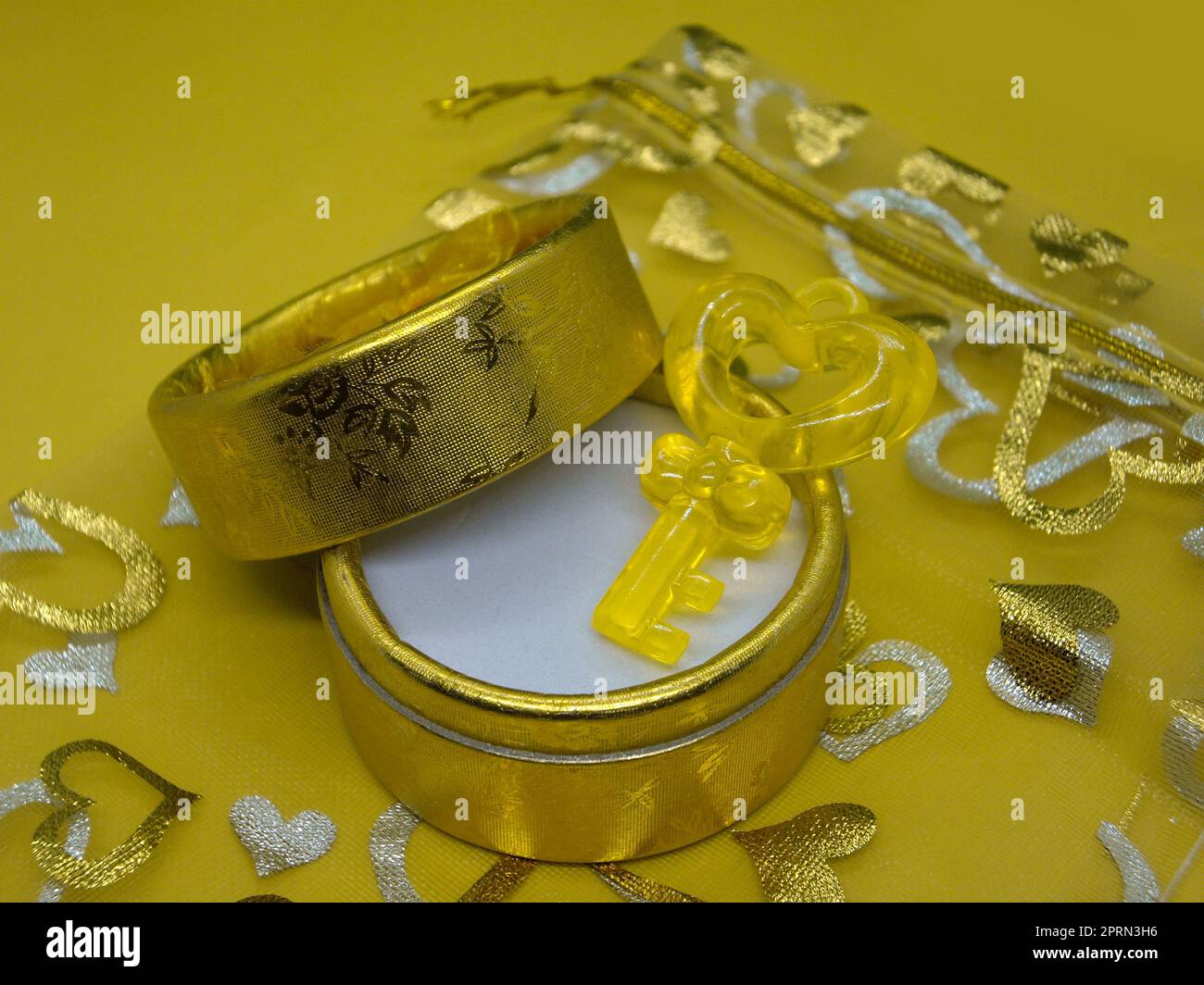 Golden key in a cylindrical box on a yellow the background Stock Photo ...