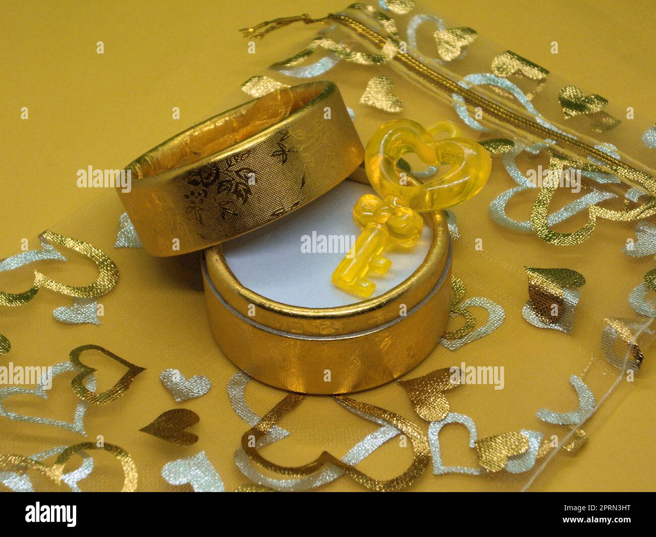 Golden key in a cylindrical box on a yellow the background Stock Photo ...
