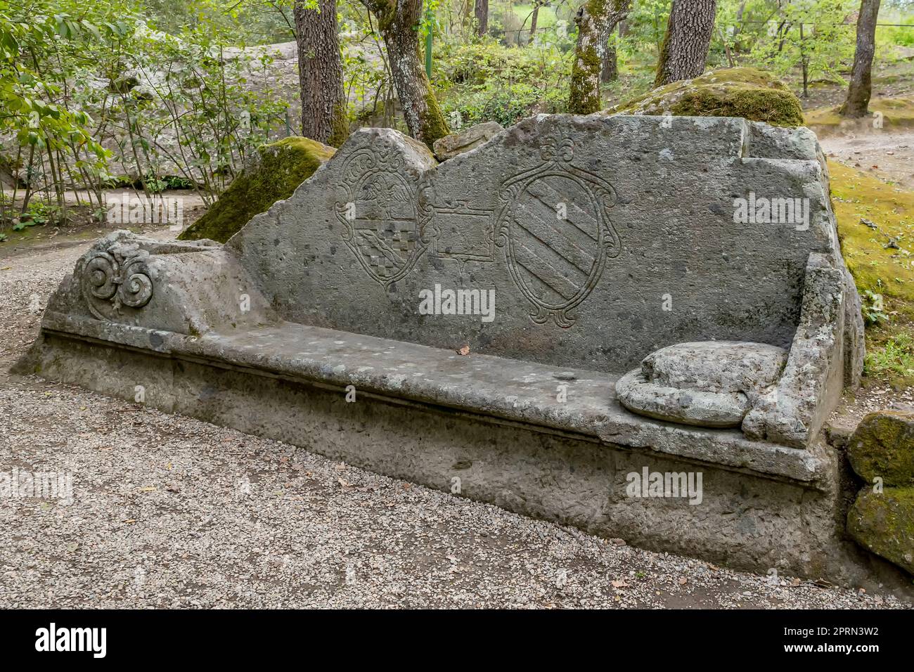 An ancient stone bench with coats of arms in the park of monsters in ...